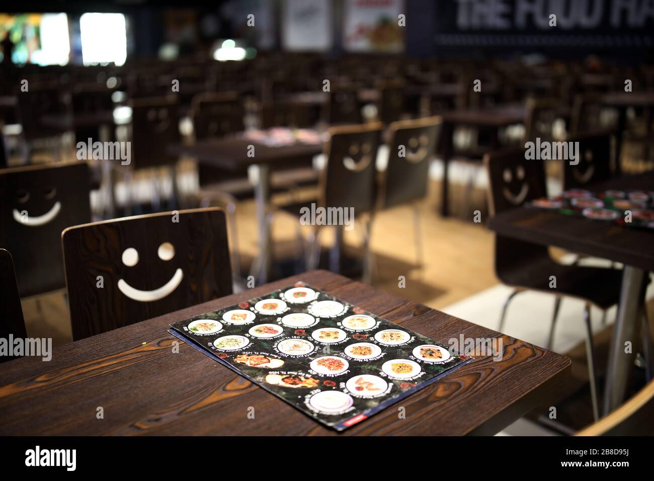 An empty restaurant seats and tables are seen at a shopping mall during ...