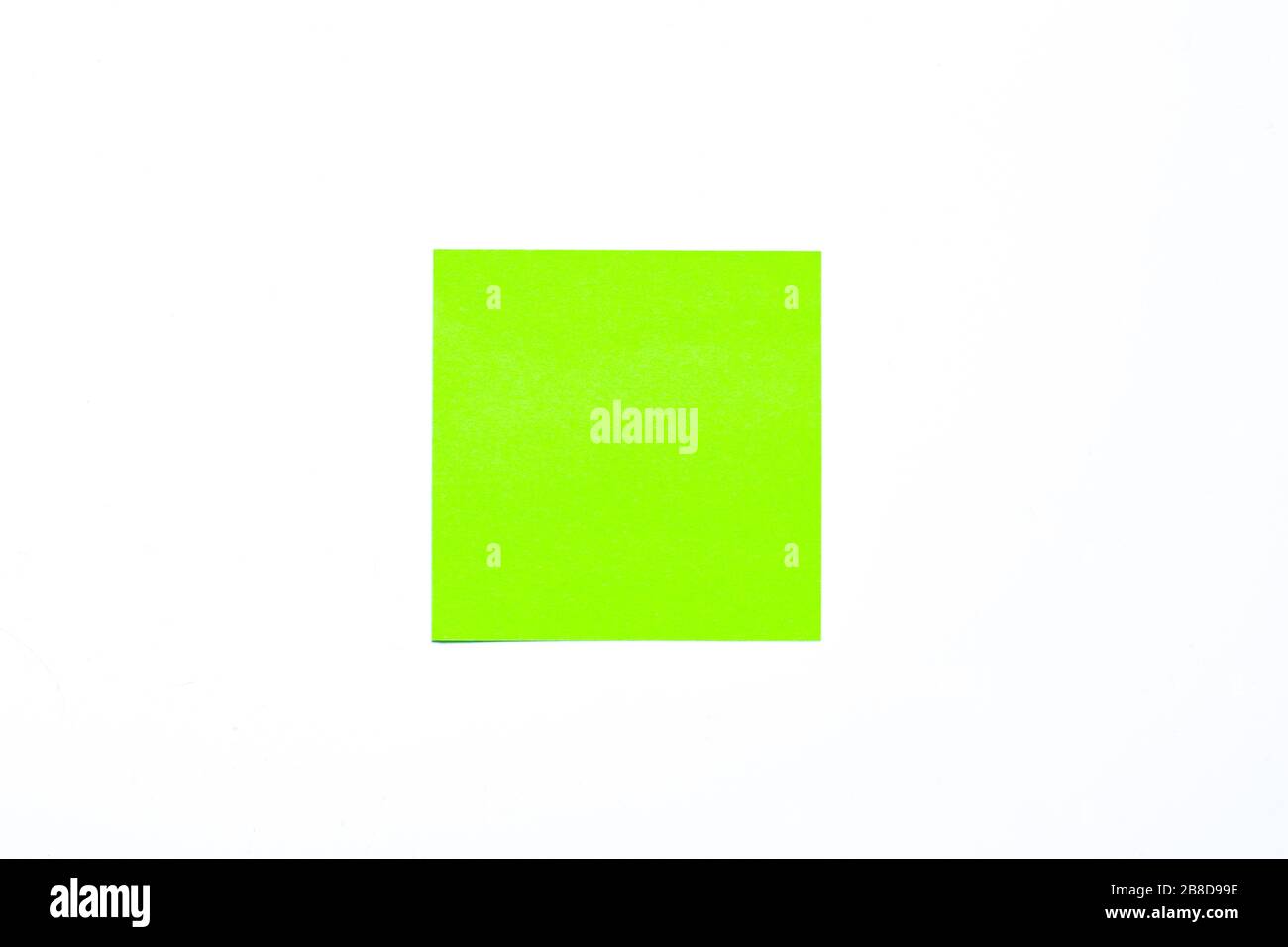 Green Post it on a white background Stock Photo - Alamy