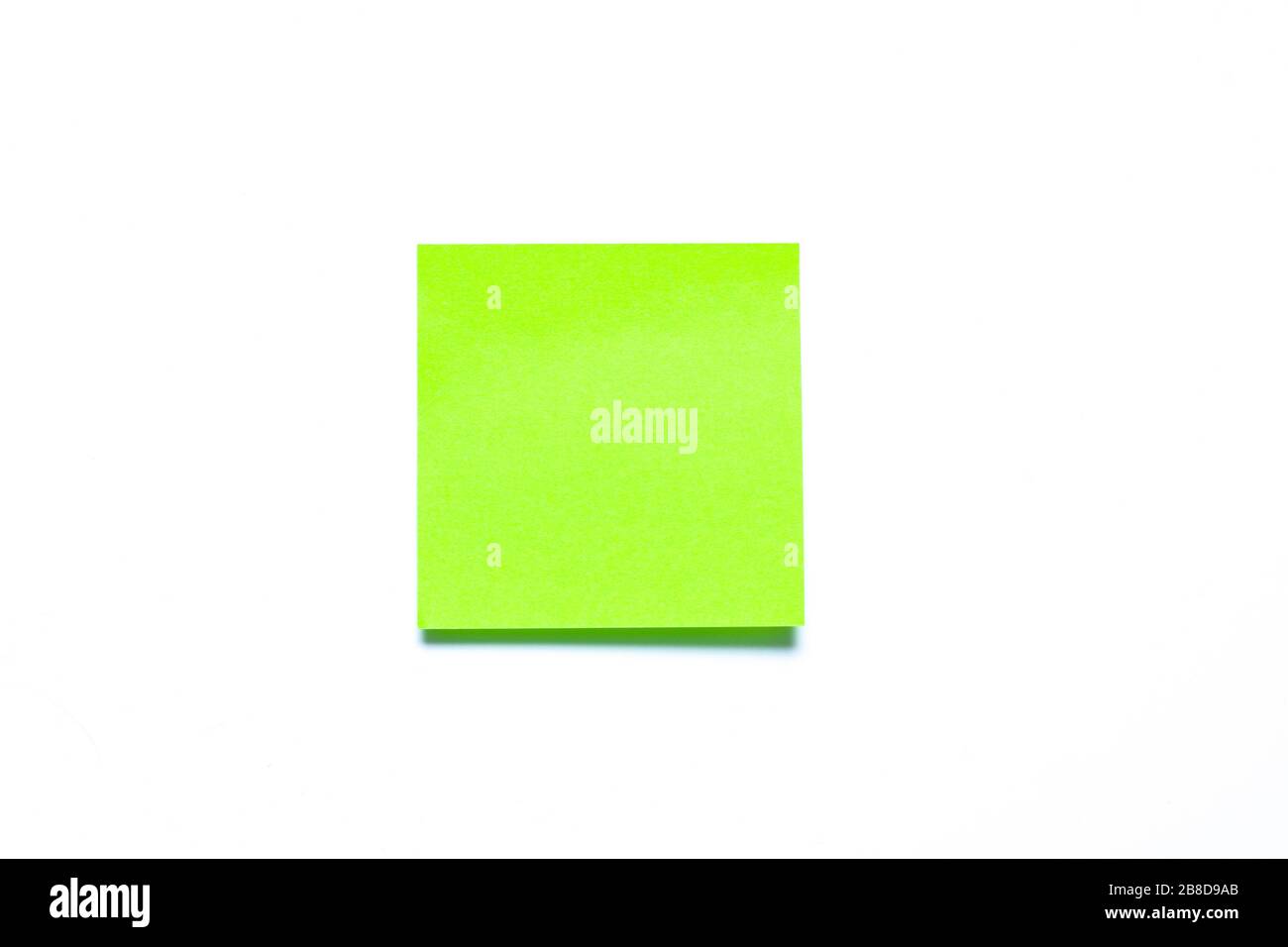 Green Post it on a white background Stock Photo - Alamy