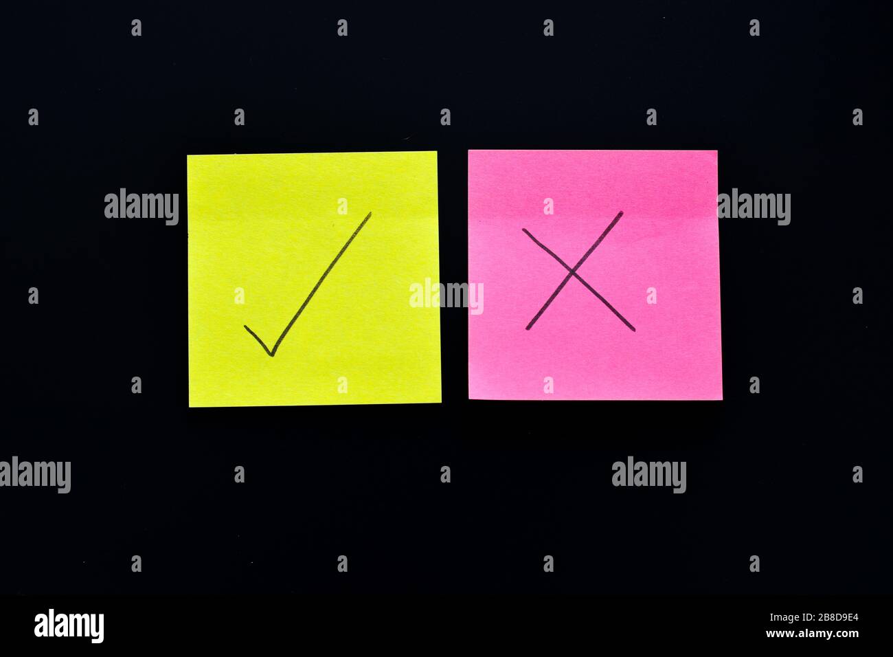Three post its on black background with a question mark and tick on it ...
