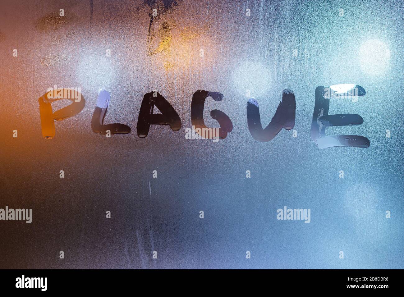 the word plague handwritten on sweat window glass surface at night ...