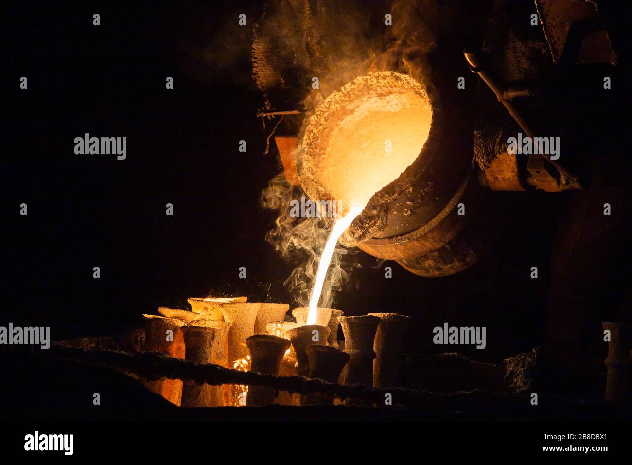 Industrial lost wax casting. The process of pouring for filling out ...