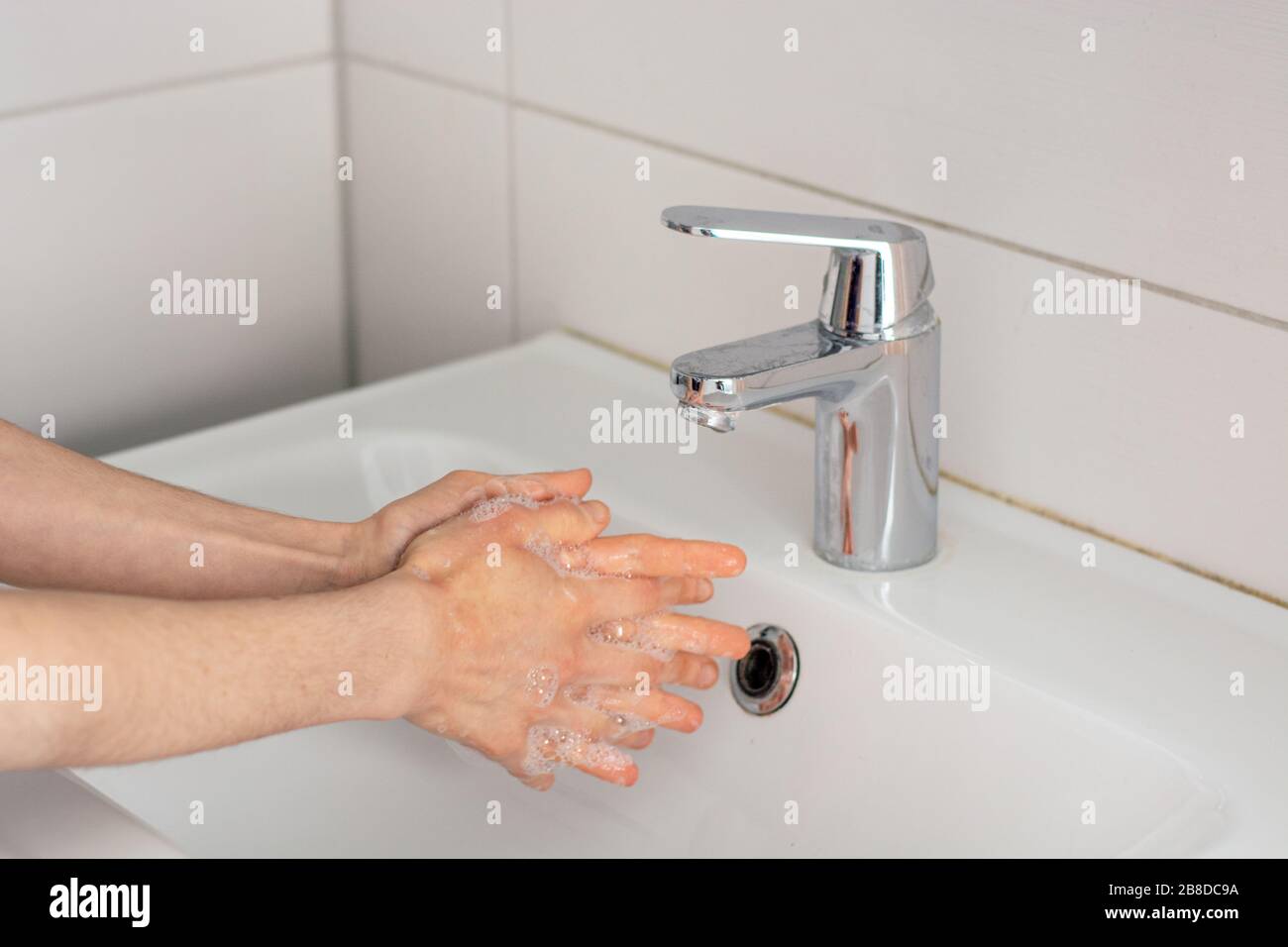 Soaping the hands before washing under tap water close up Stock Photo ...