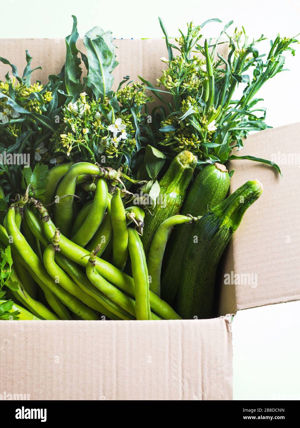 Green produce in cardboard box Stock Photo - Alamy