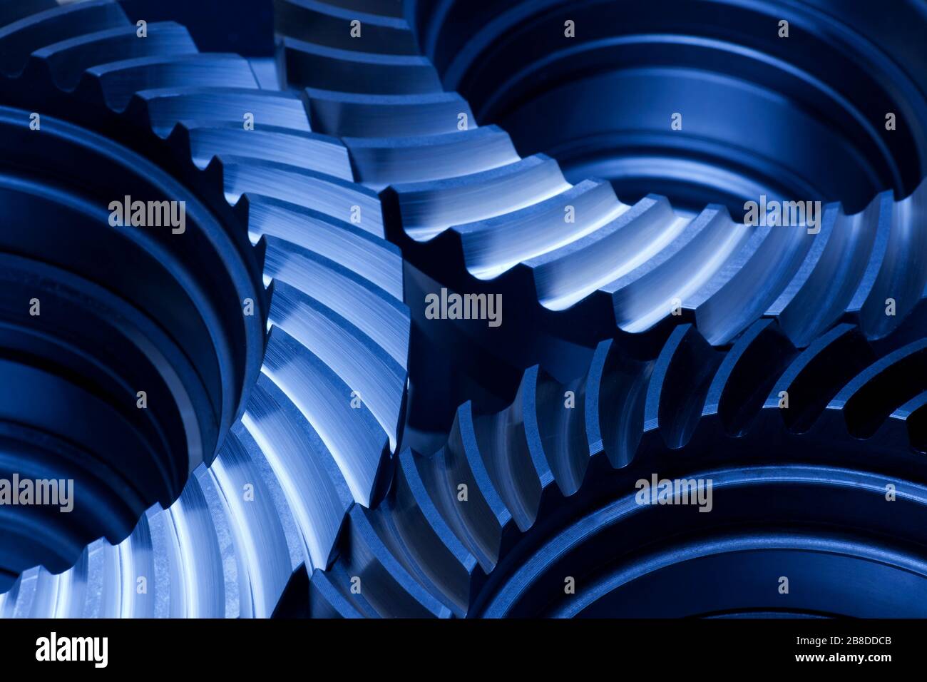 Close-up of three gear wheels in an engine in dark blue Stock Photo - Alamy