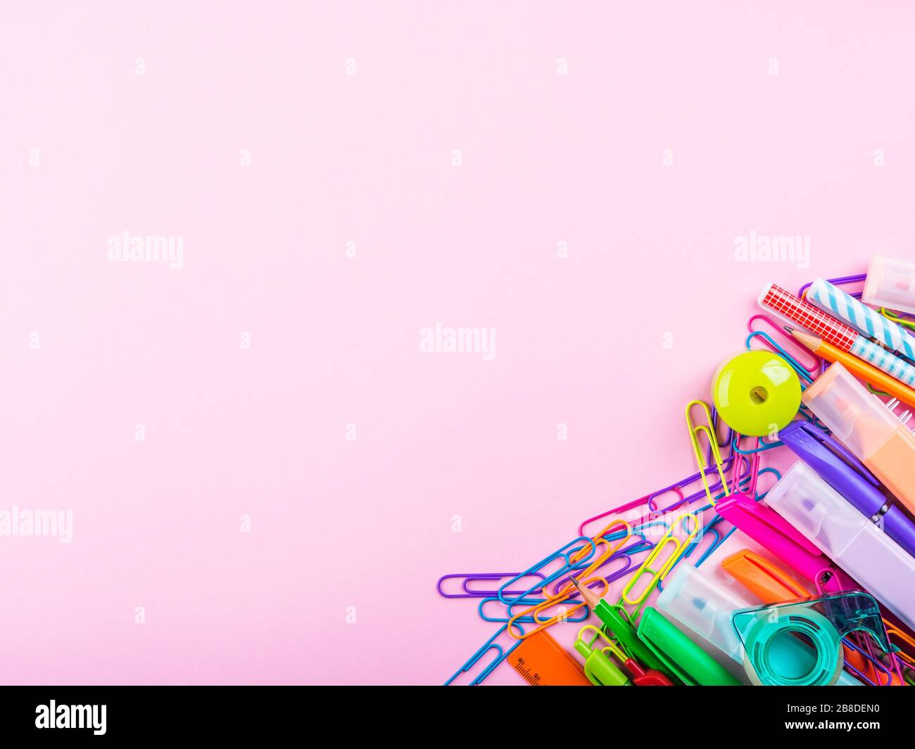 Colorful stationery office supply frame on pink Stock Photo - Alamy