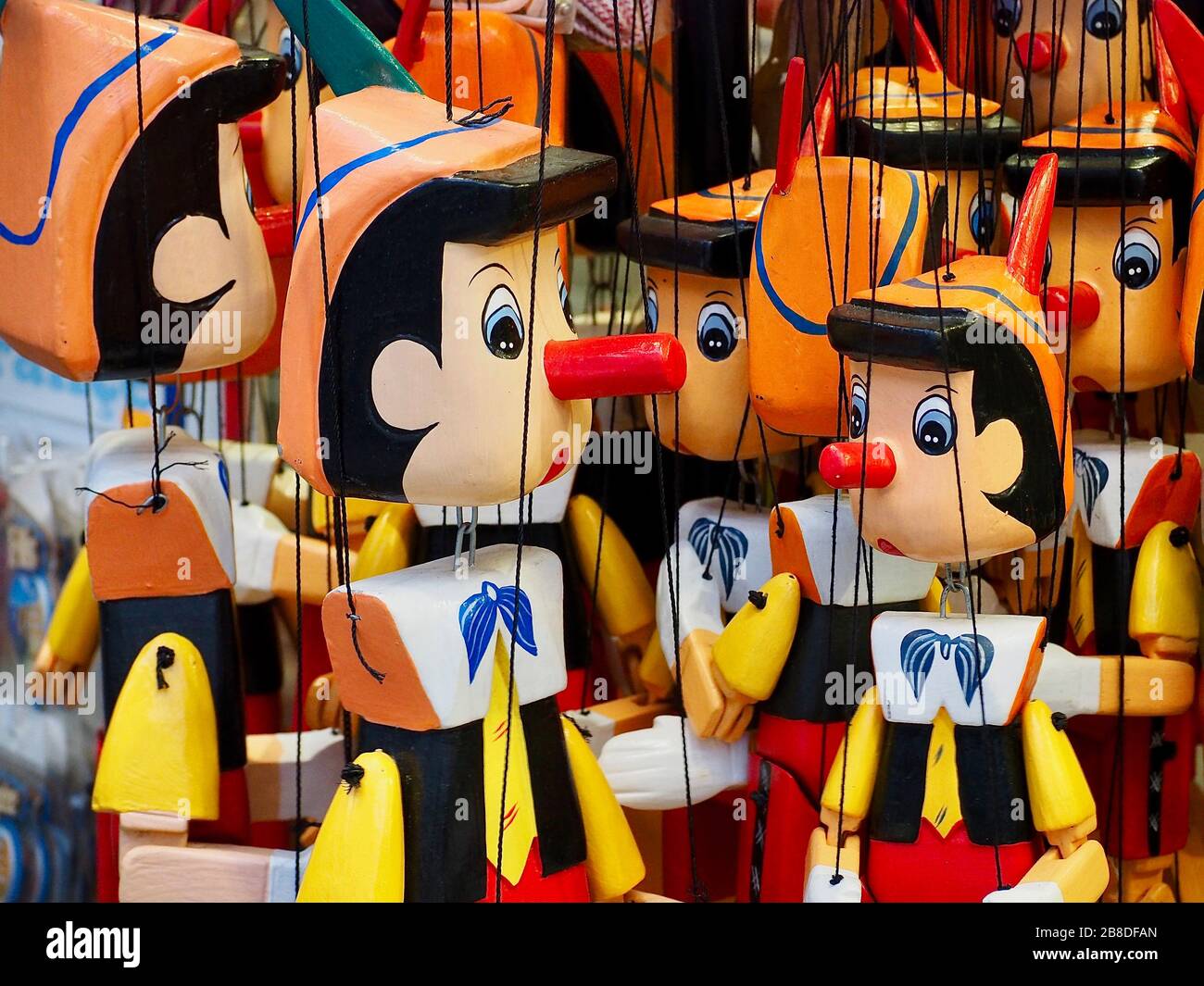 Macro of Pinocchio puppets hanging on strings Stock Photo - Alamy