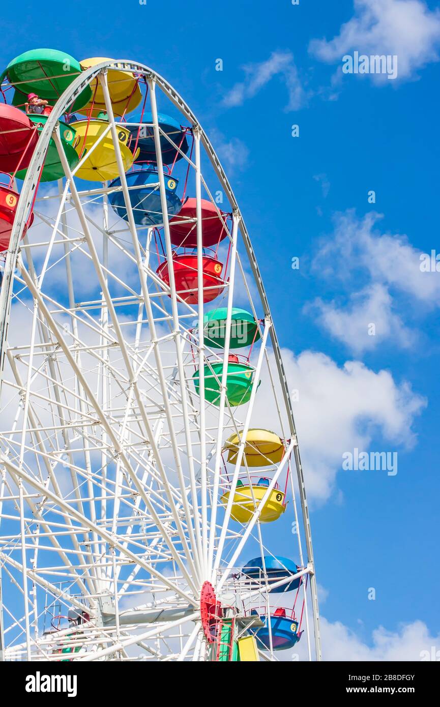 colorful ferris wheell against blue sky Stock Photo - Alamy