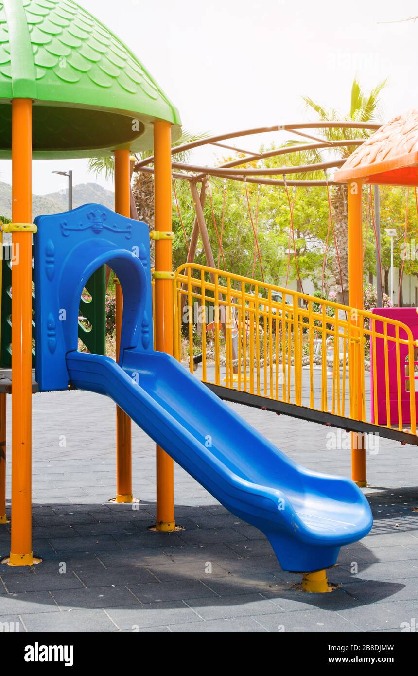 Colorful children playground activities in public park surrounded by ...
