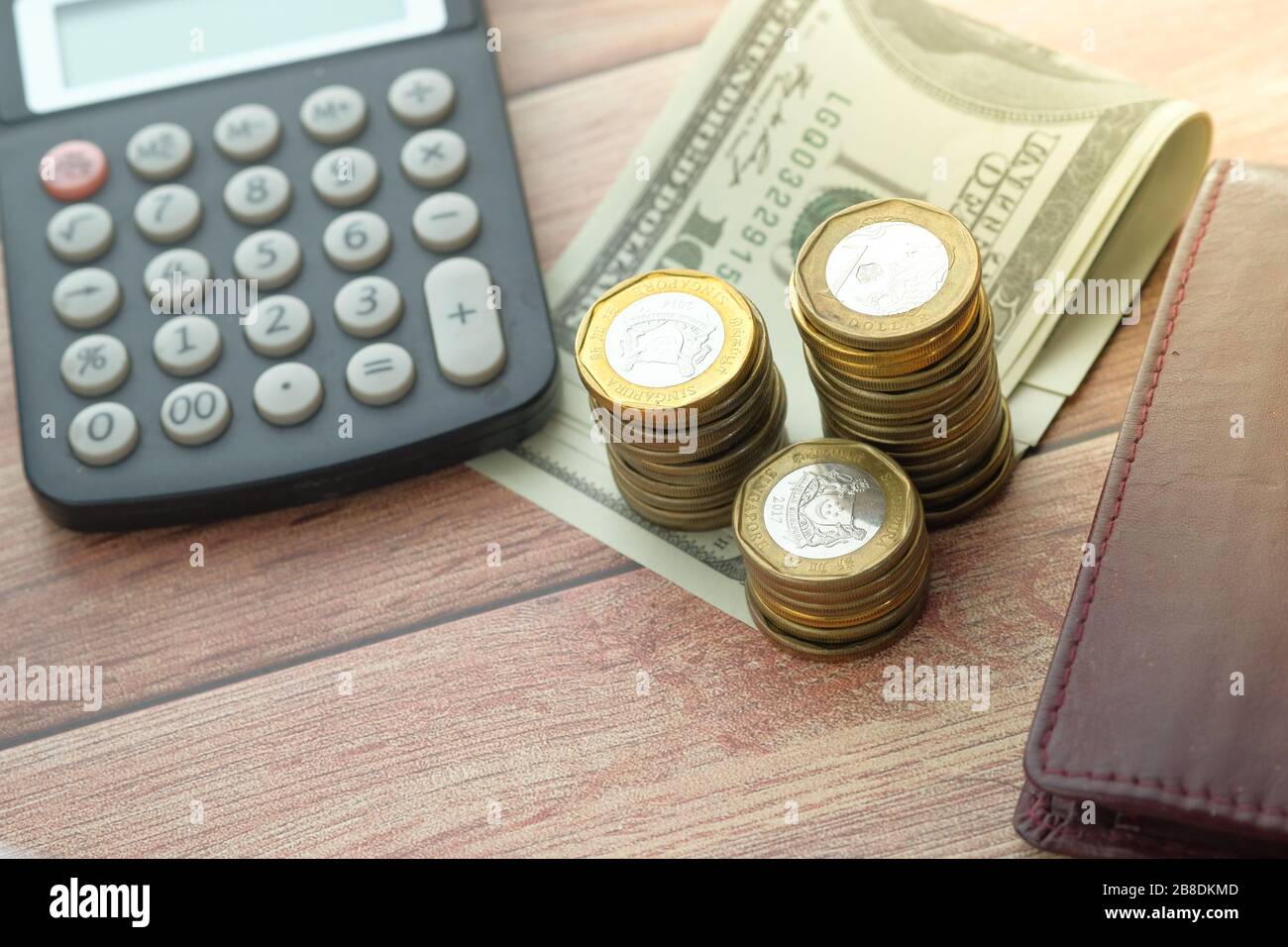 close up of stack of coin, cash and wallet on table Stock Photo - Alamy