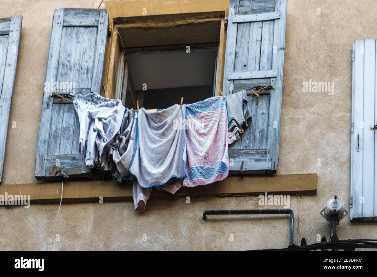 Laundry Drying in a Window Stock Photo - Alamy
