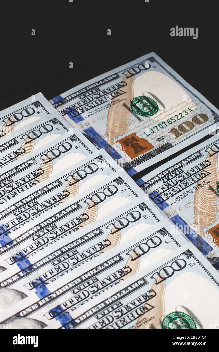 Dollars close up, vertical orientation, black background Stock Photo ...