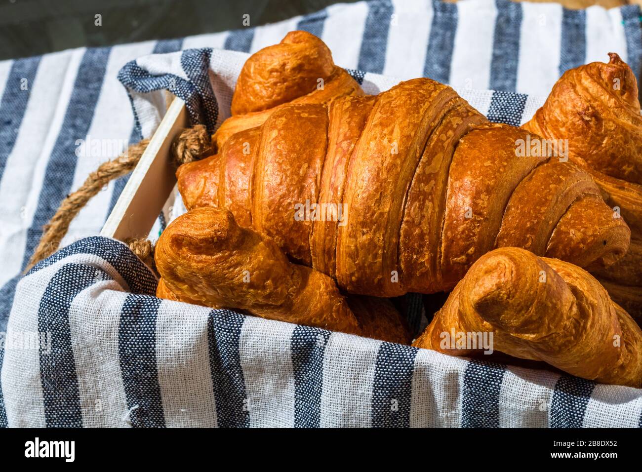 Fresh croissant, puff pastry and buttered french croissant on wooden ...