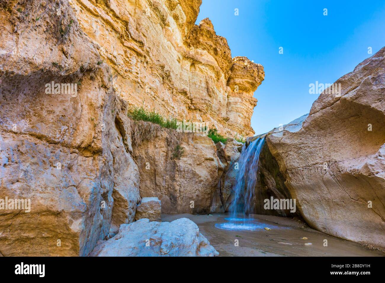 Waterfall in mountain oasis Stock Photo - Alamy