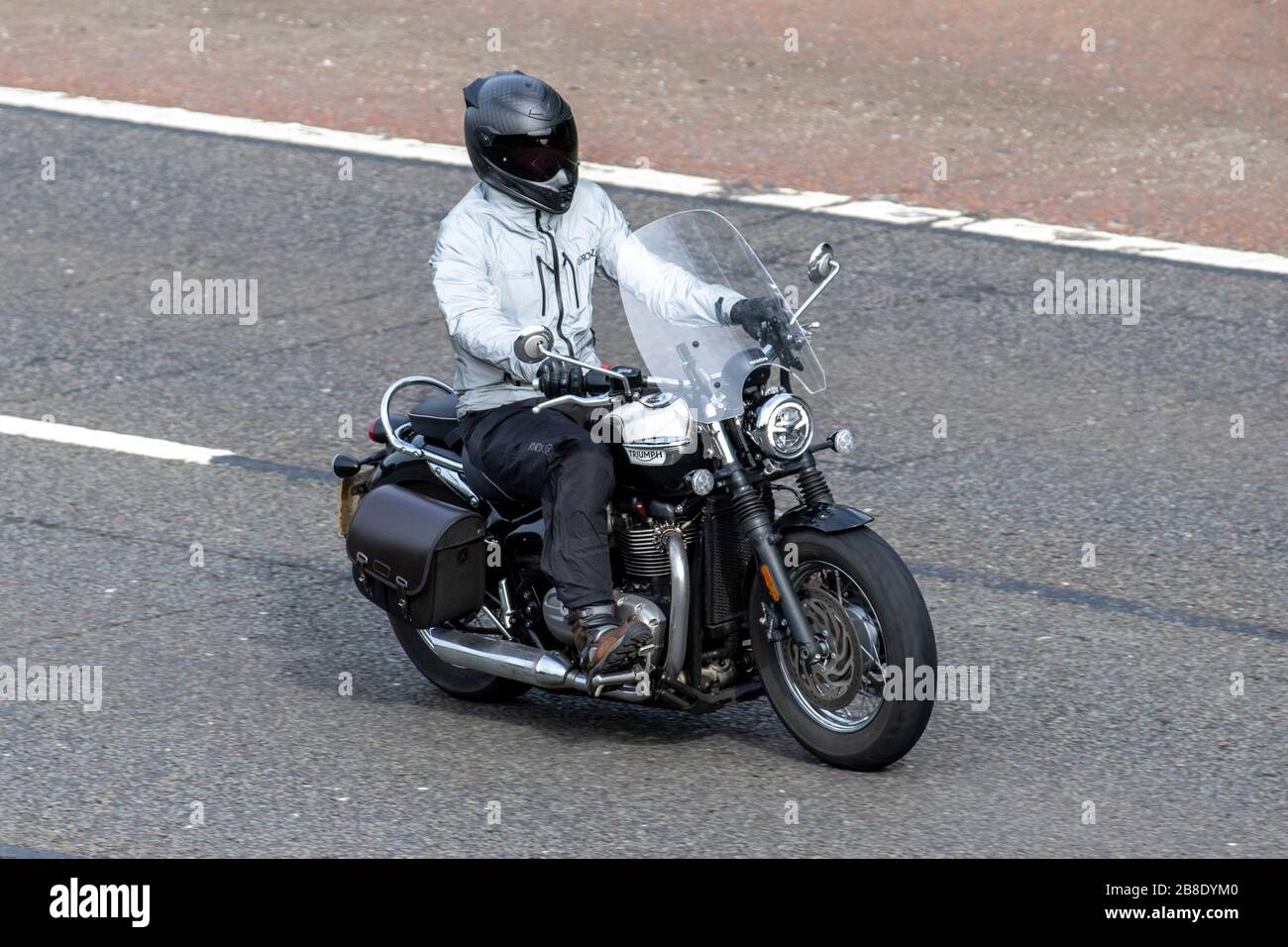 Vintage Triumph motorcycle rider; Vehicular traffic, two wheeled ...