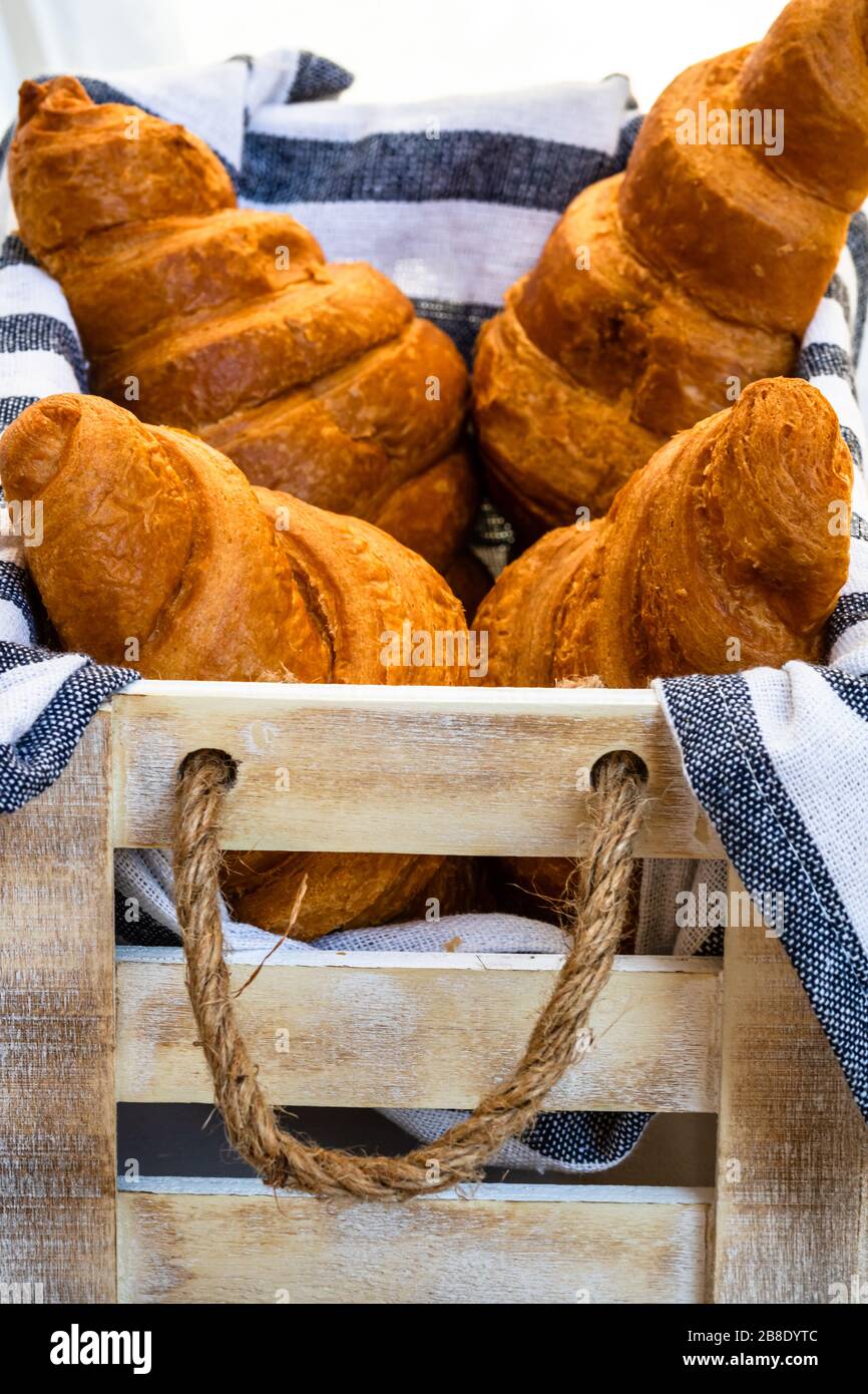Fresh croissant, puff pastry and buttered french croissant on wooden ...