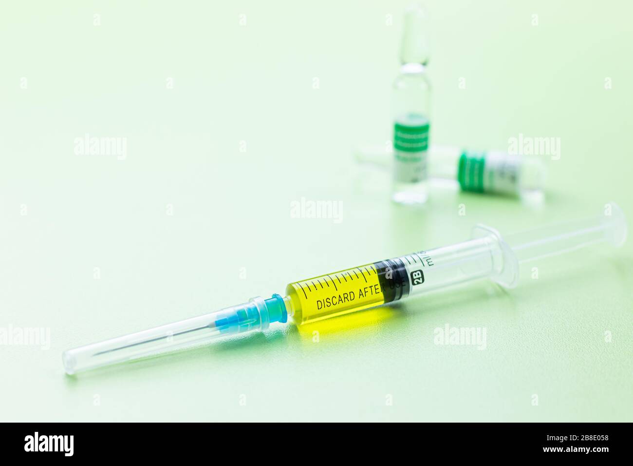 Small bottle and syringe on medicine table ready for injection vaccine ...