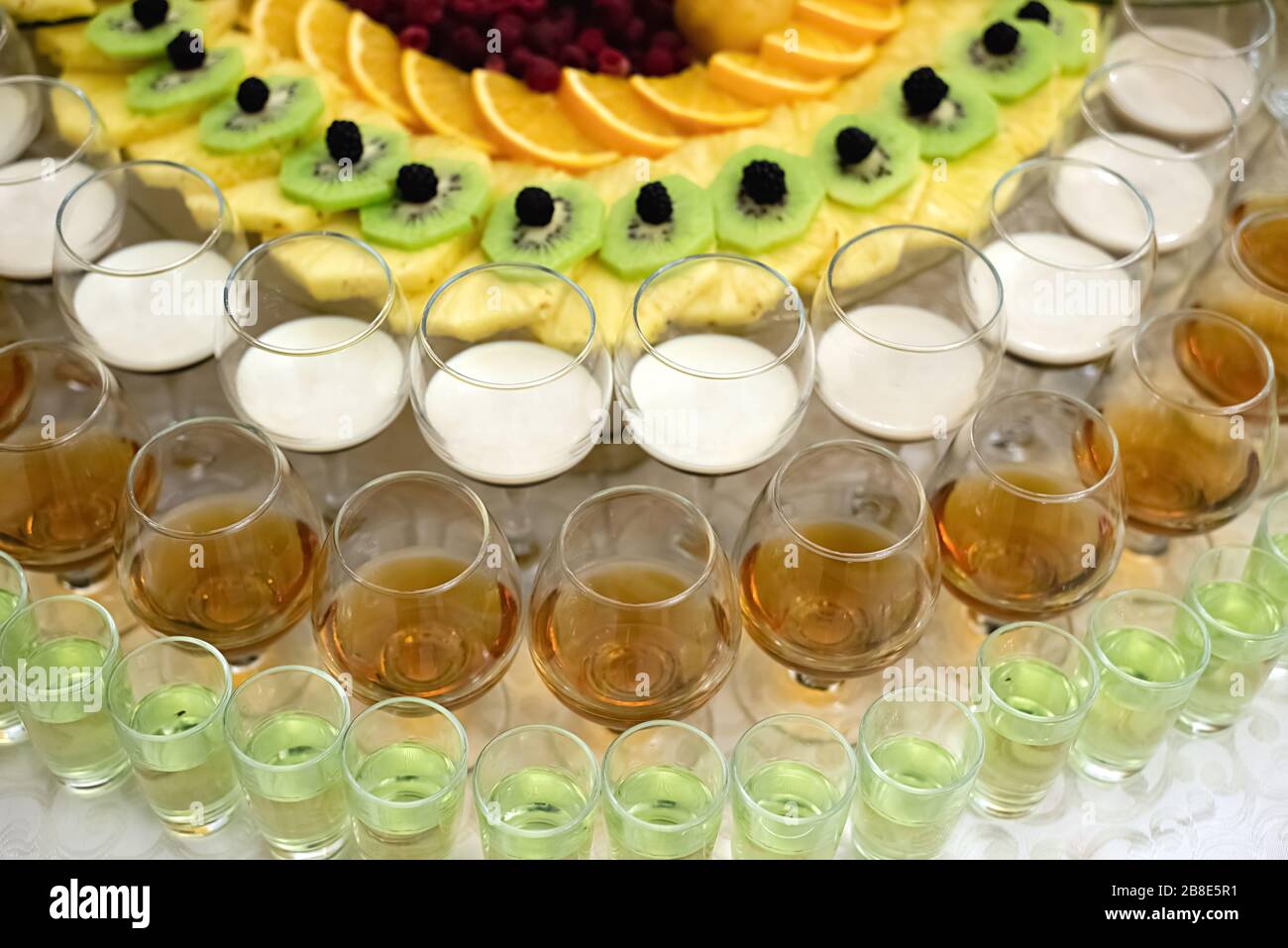 Festive table with cold exotic alcoholic beverages, cocktails and ...