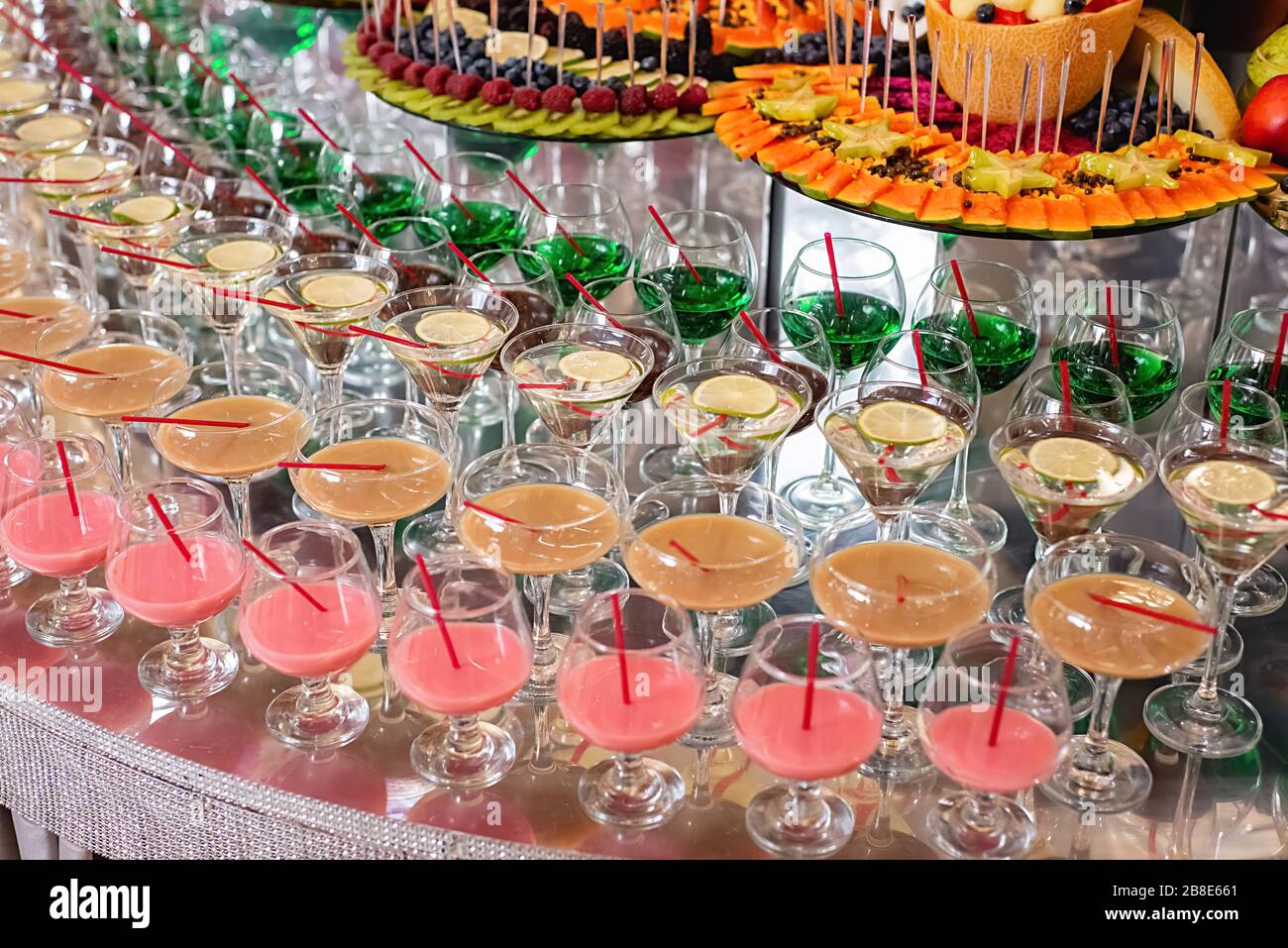 Different fresh alcoholic cocktail in glass on bar table, many colorful ...