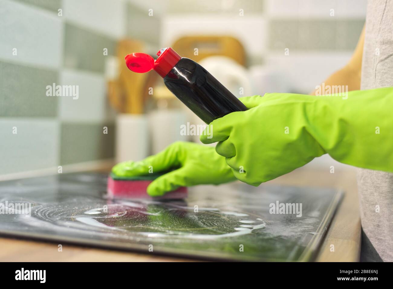 Closeup of hand woman cleaning modern cooking glass ceramic electric ...