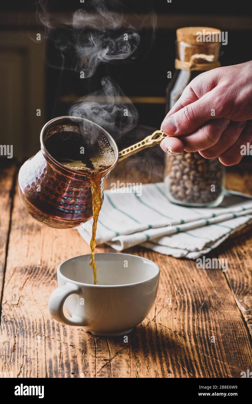 Pouring turkish coffee into white cup Stock Photo - Alamy