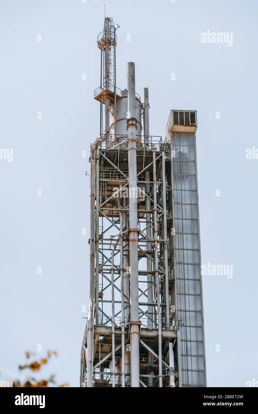 A vertical view from of a tall contemporary oil refinery tower building ...