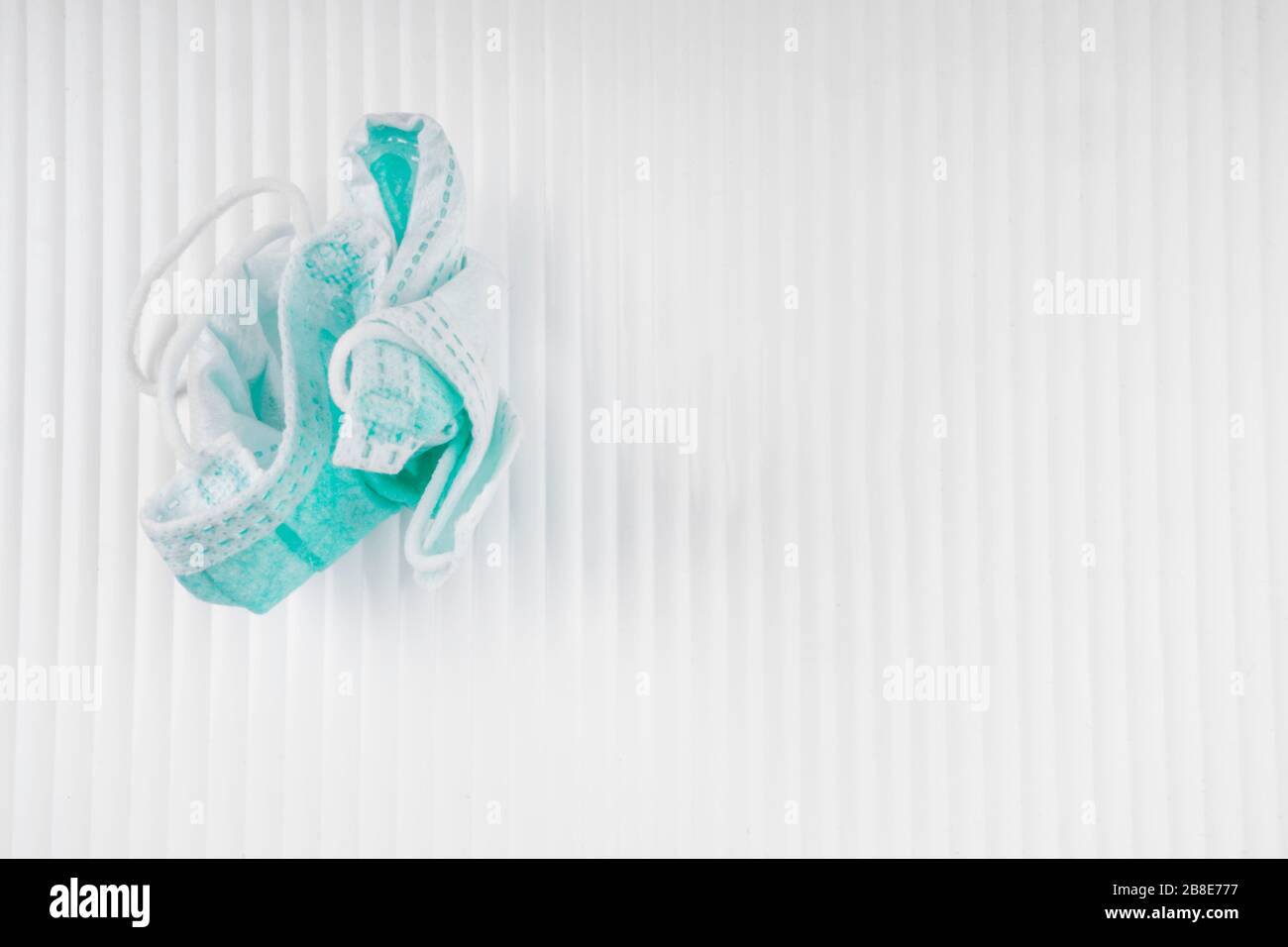 crumpled disposable face mask on white background Stock Photo - Alamy