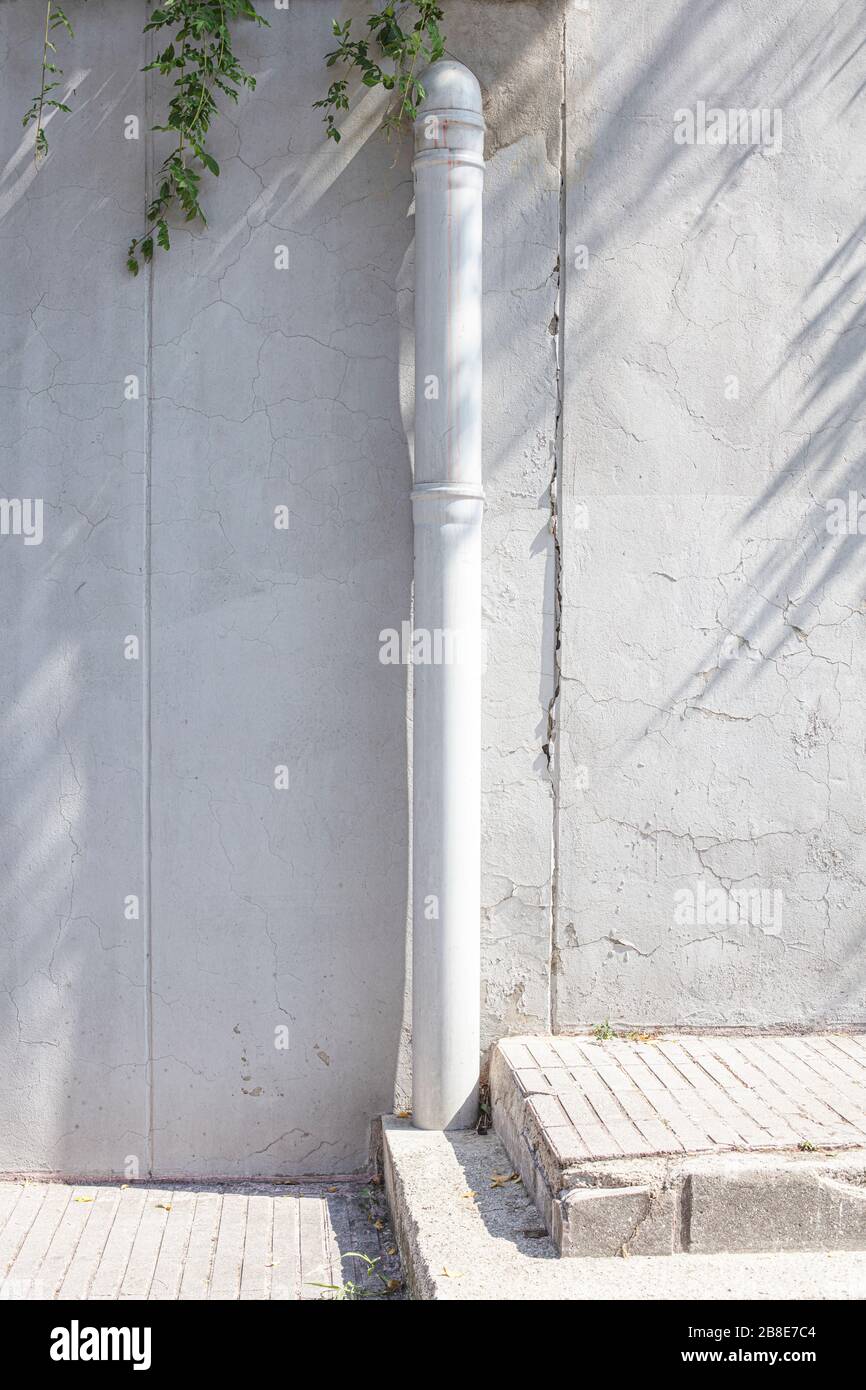 White plastic sewage water pipes on concrete wall Stock Photo - Alamy