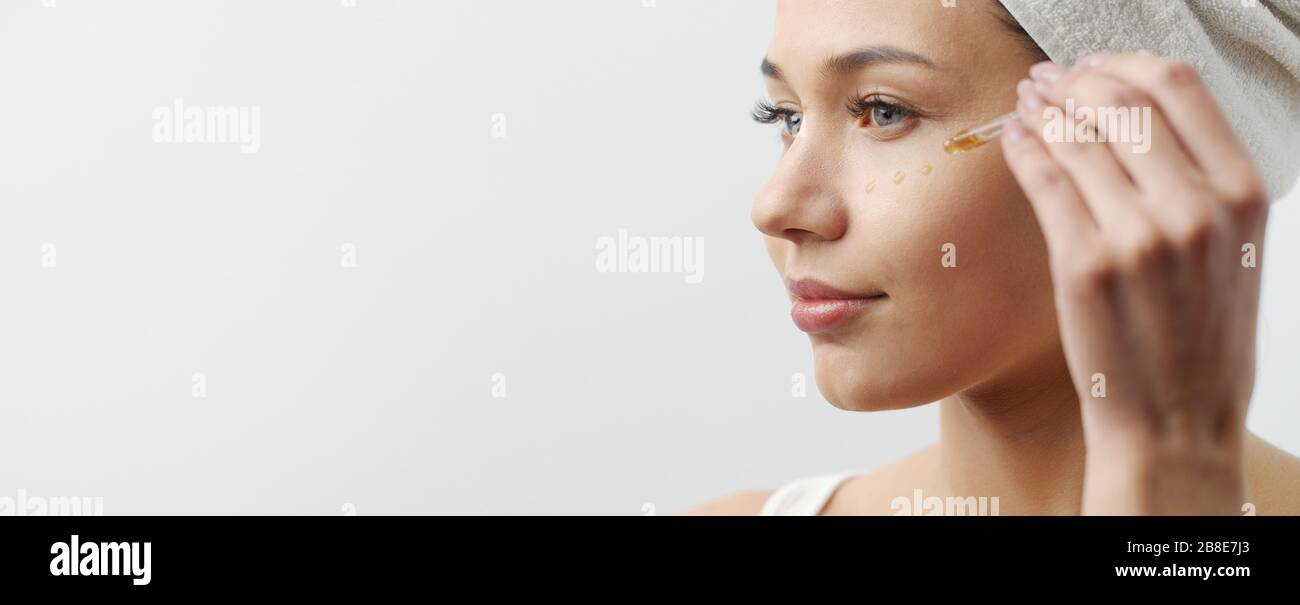 Young female applying refinisher Stock Photo - Alamy