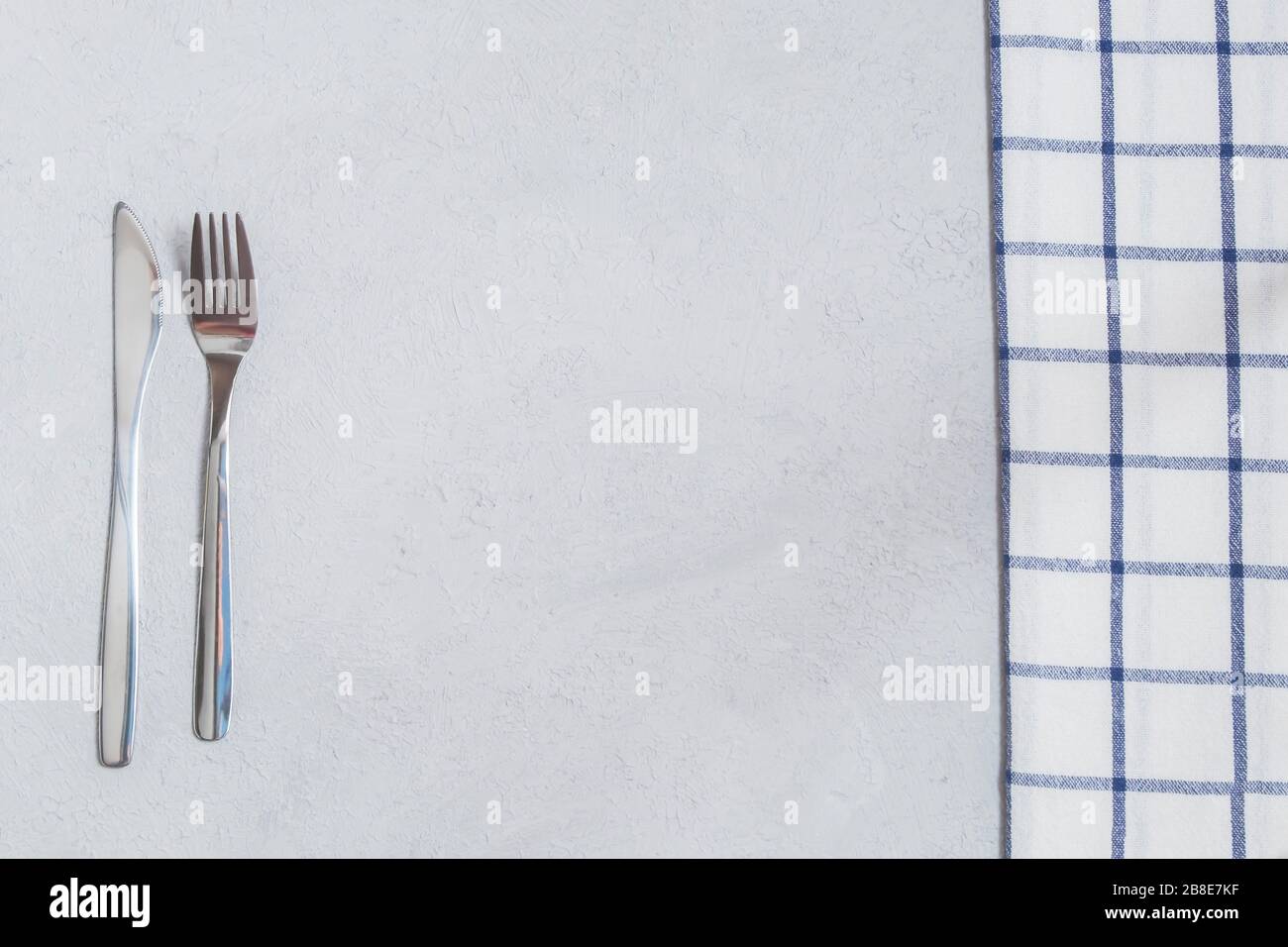Top view of silverware and table cloth on neutral table background ...