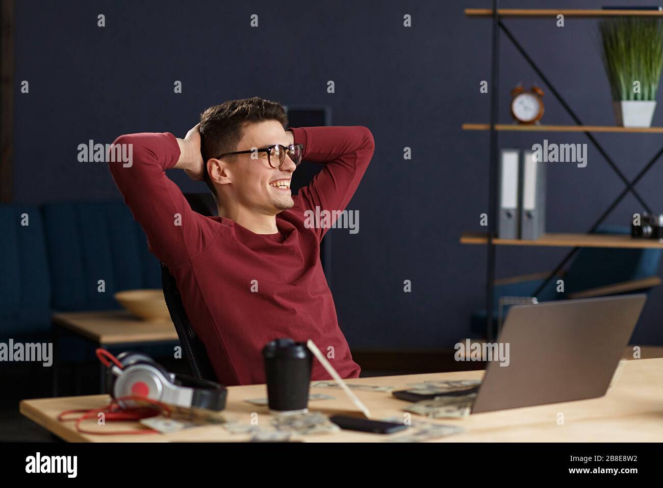 I'm rich. Portrait of a young freelancer or businessman in a hom Stock ...