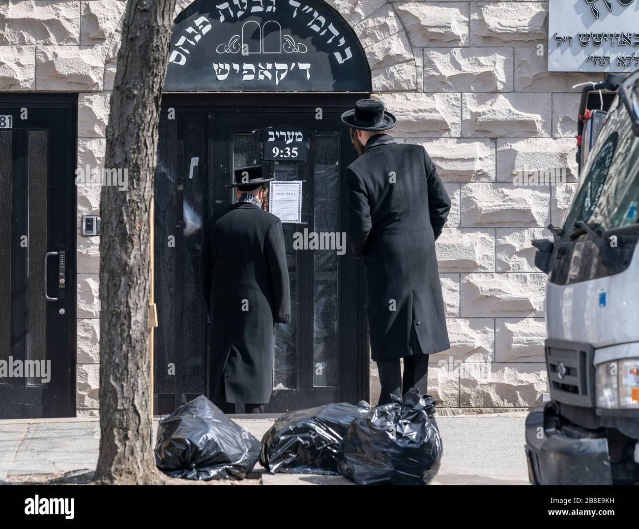 New York, NY - March 21, 2020: Hasidic Satmar Jewish men read signs on ...