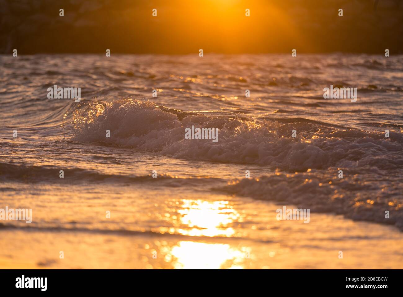 sea waves warm red sunset beach Stock Photo - Alamy