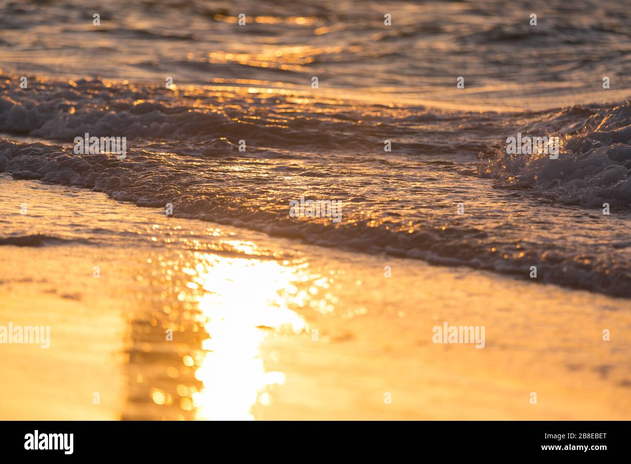 sea waves warm red sunset beach Stock Photo - Alamy