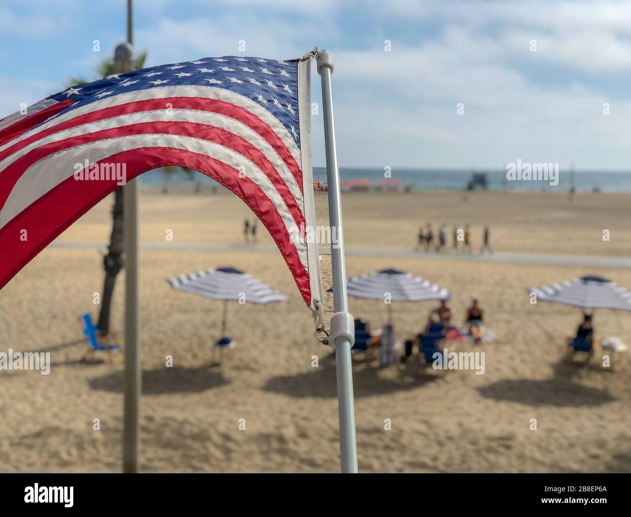 American flag with the beach on the background in Santa Monica beach ...