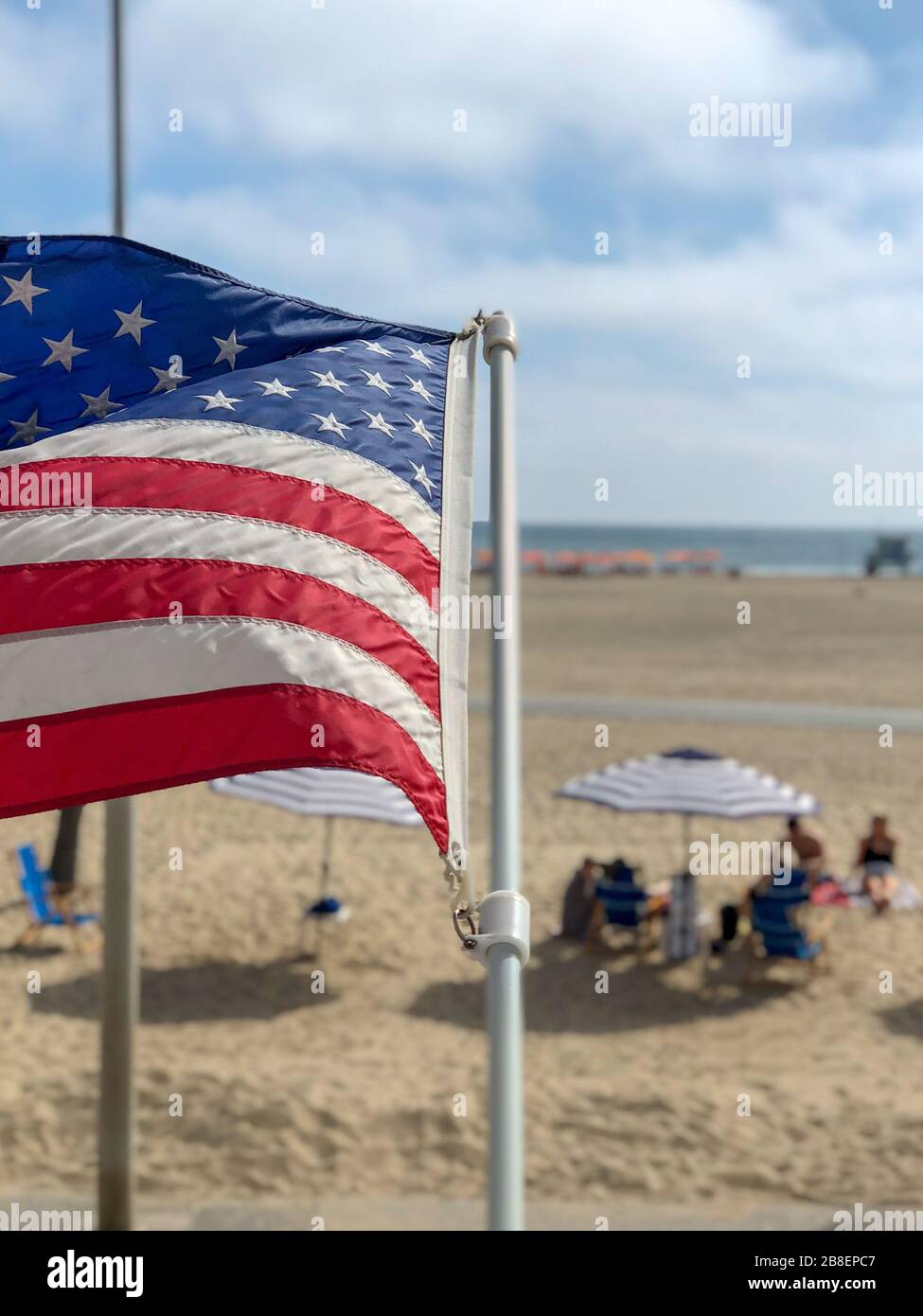 American flag with the beach on the background in Santa Monica beach ...