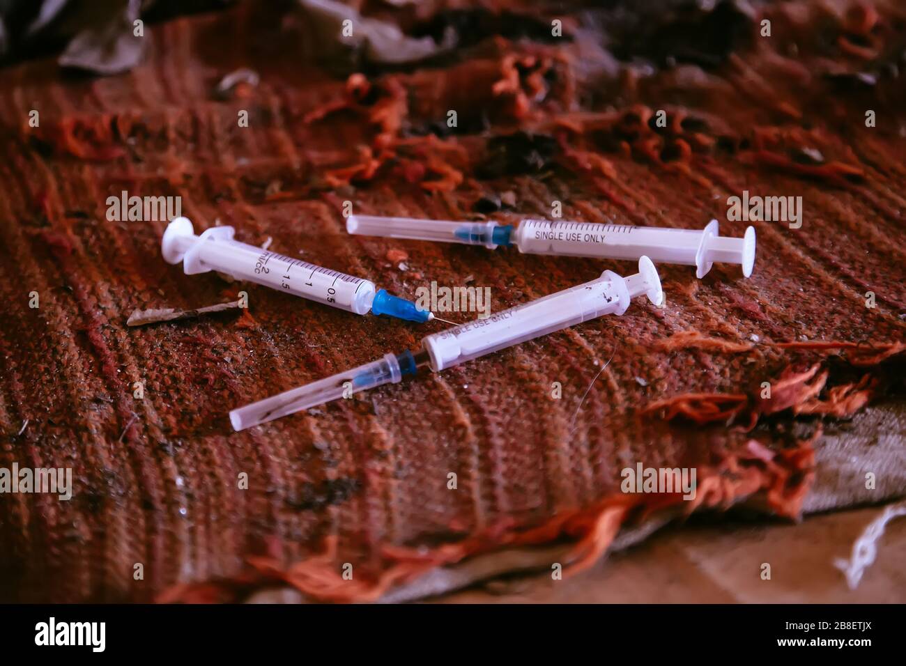 Used by drug addict syringe needle on old cloth Stock Photo - Alamy