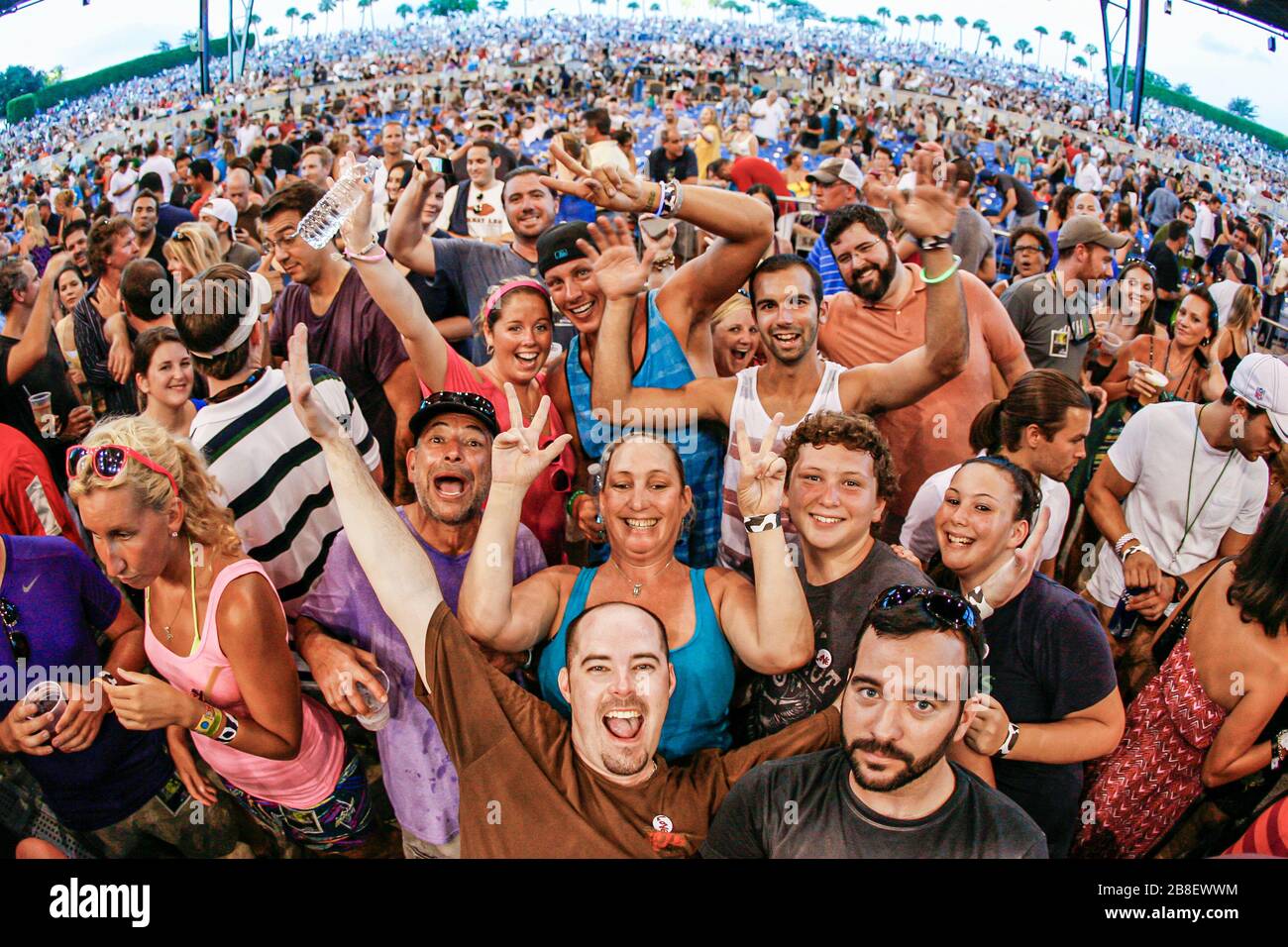 Concert goers crowd together in anticipation of the headliners to hit ...