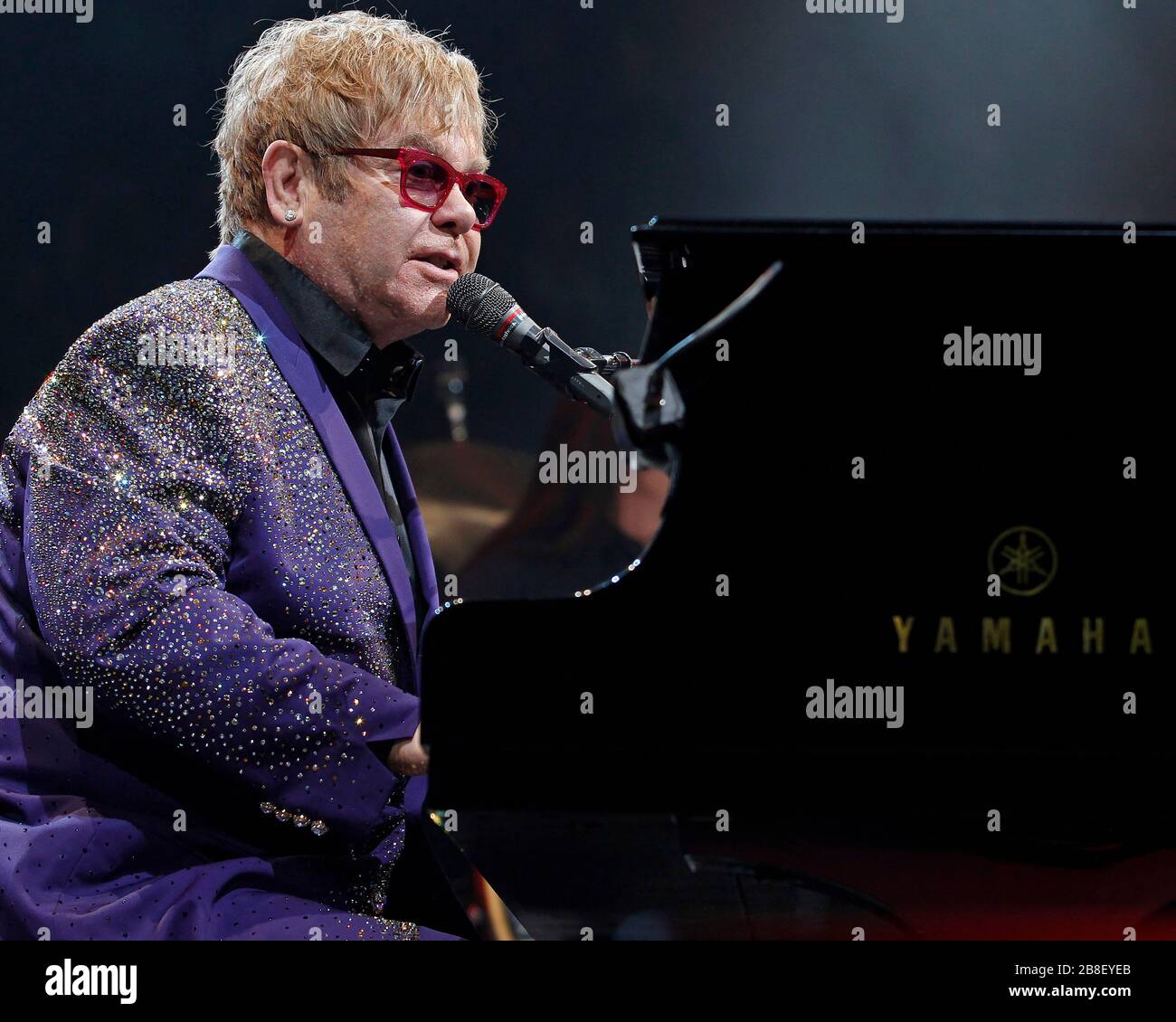 Singer Elton John performs drummer Nigel Olsson and the rest of the ...