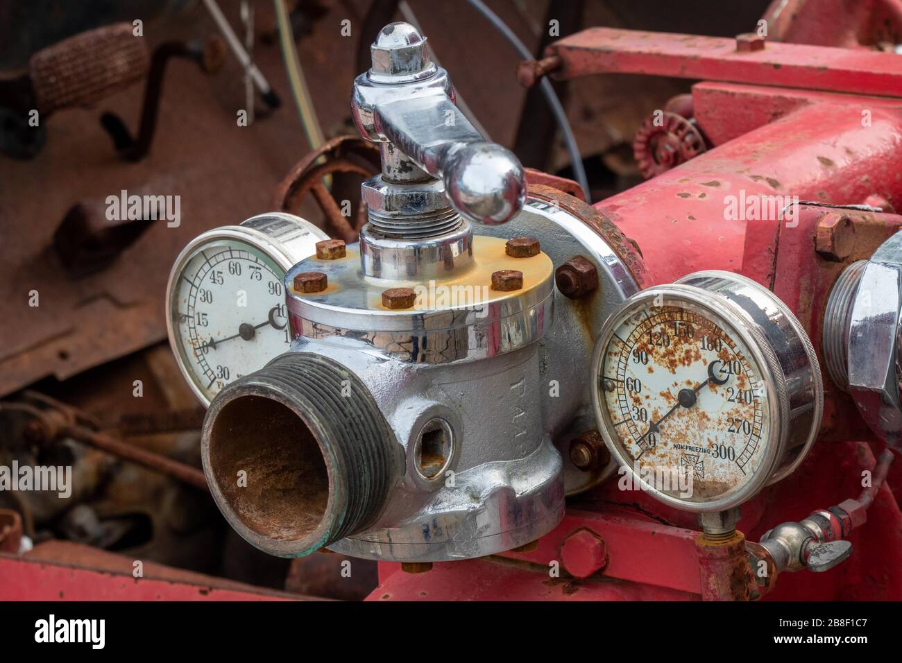 Rust valve on an old fire engine in a junk yared Stock Photo - Alamy