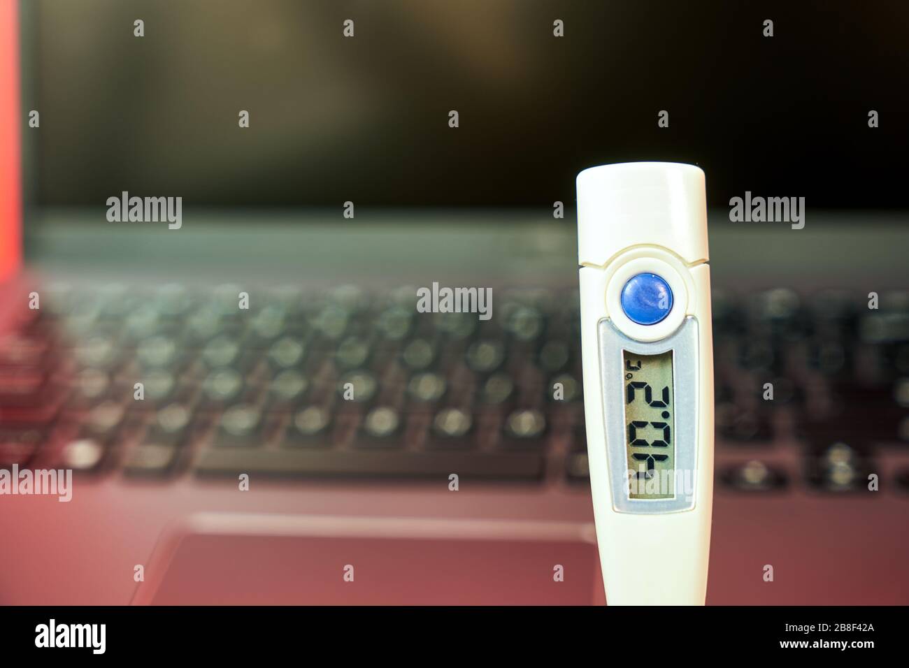 Electronic thermometer showing a high fever on the background of the ...