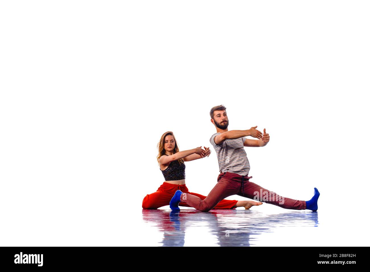 Guy and girl in dance movement. Modern style young dancers performing ...