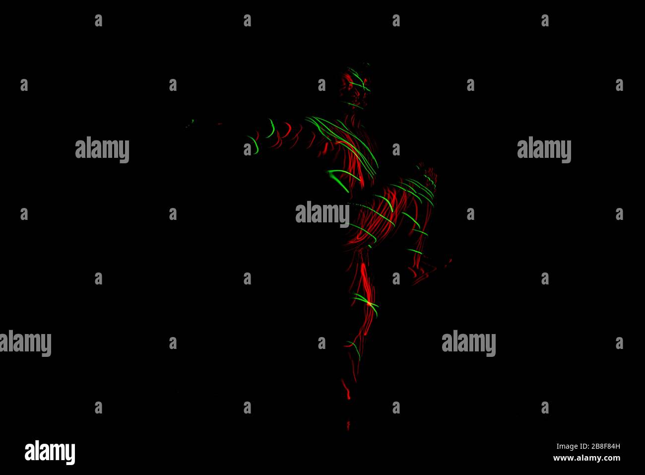 Laser show outline of a modern dancer performing an artistic ...