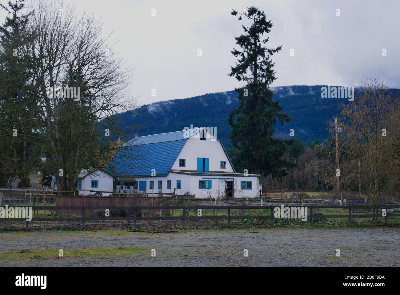 Canadian barn on a farm with mountain backdrop Stock Photo - Alamy