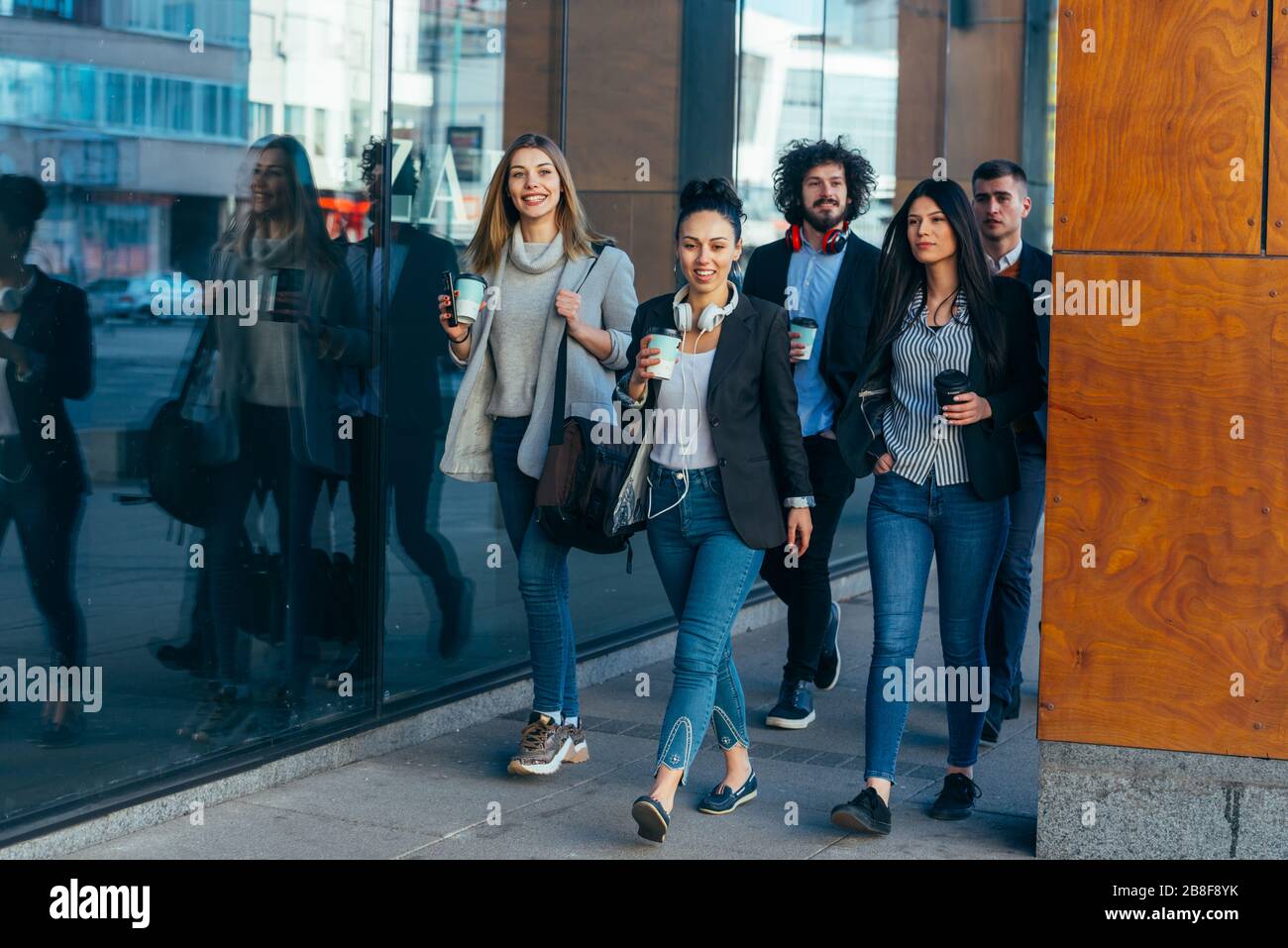 Group of colleagues on a business trip (euro trip) walking together at ...