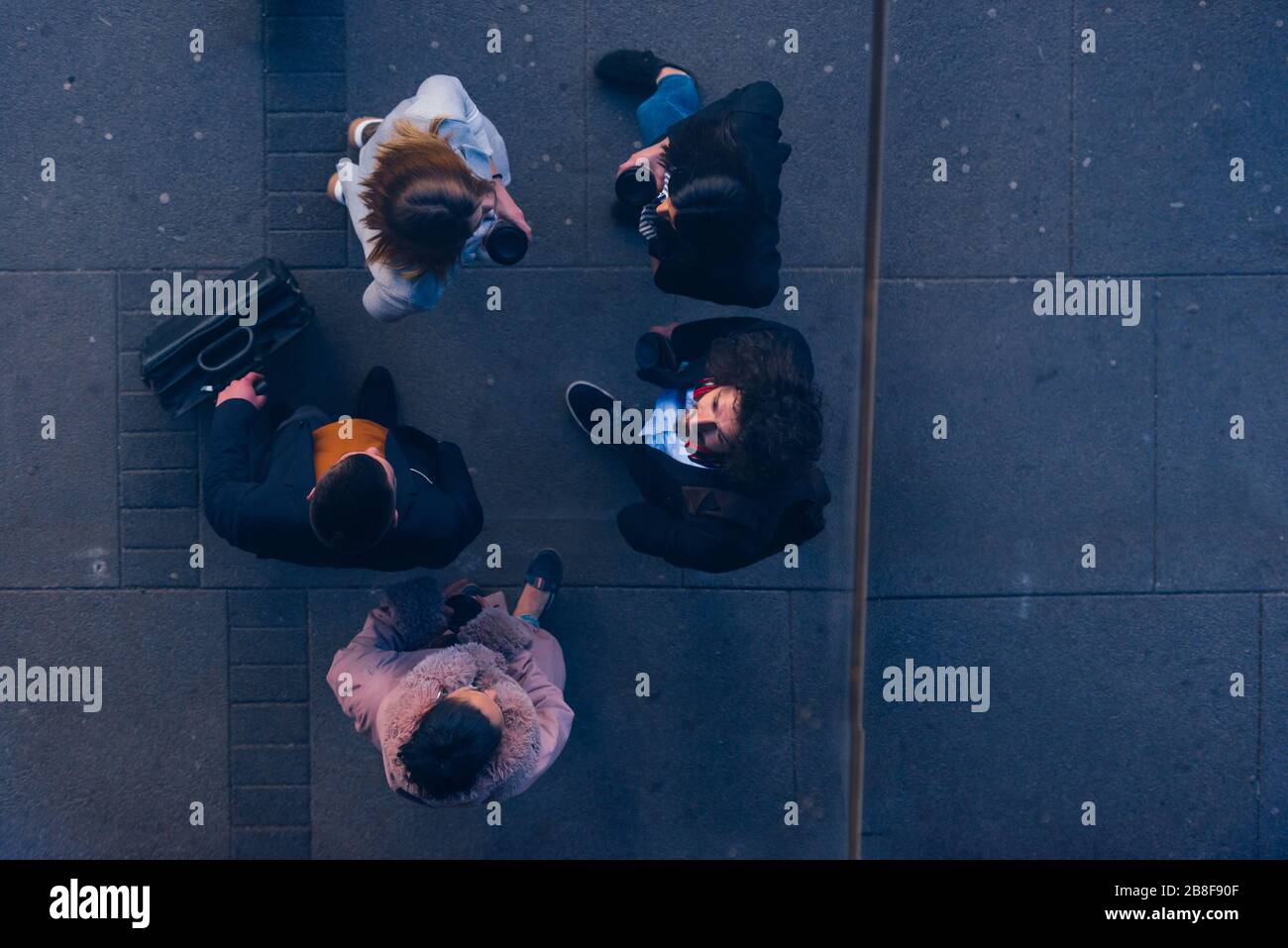 Bird eye perspective of a team of colleagues (friends) standing next to ...