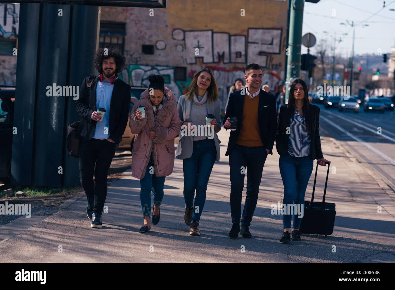 Group of friends (colleagues) hanging out in an urban area Stock Photo ...