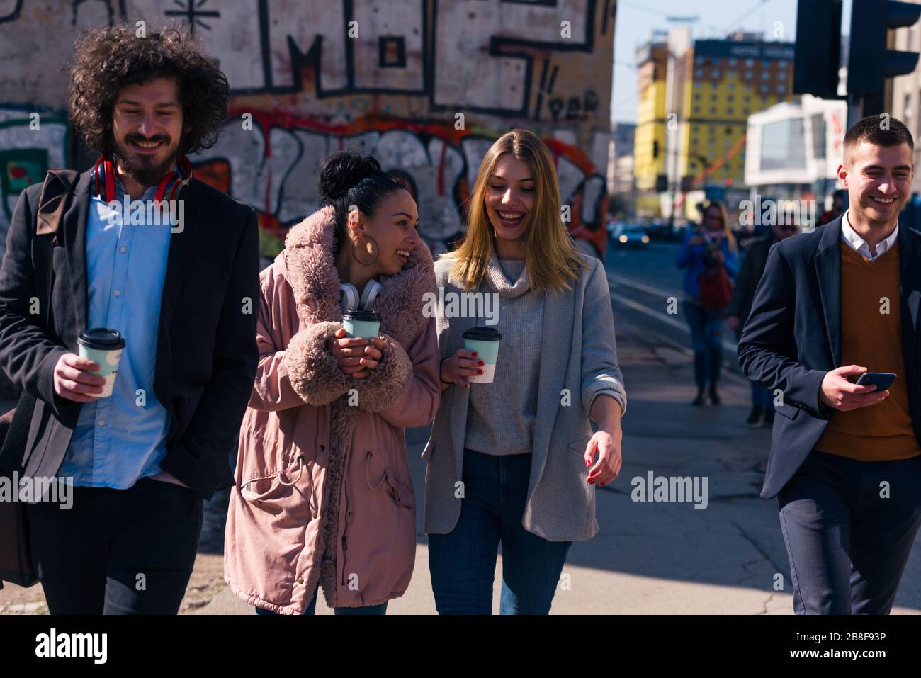 Group of friends (colleagues) hanging out in an urban area Stock Photo ...