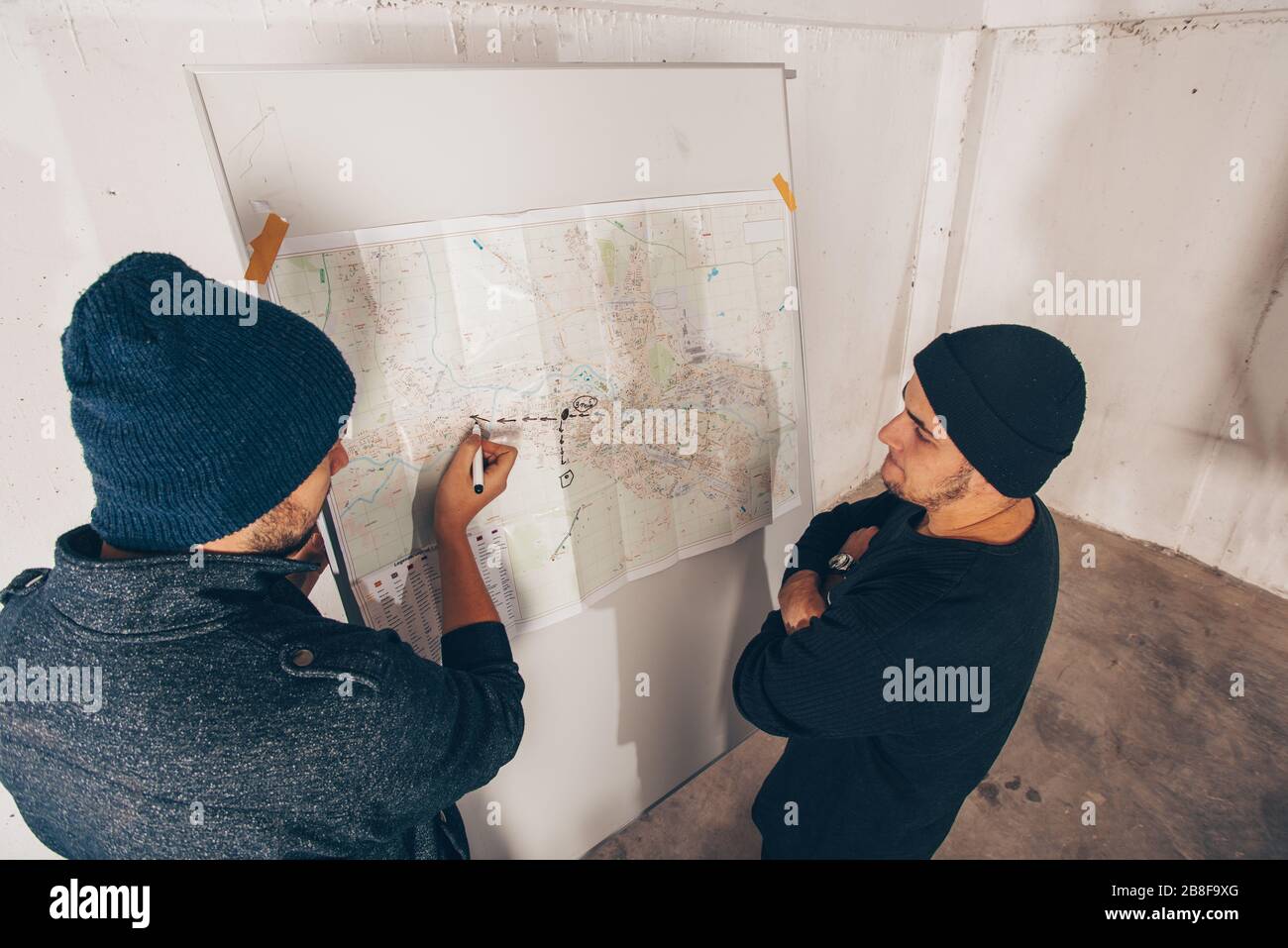 Adult intruders are making a plan on the map about robbery Stock Photo ...