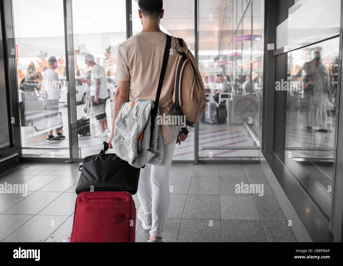 Travelling guy wearing smart casual style clothes walking away with his ...